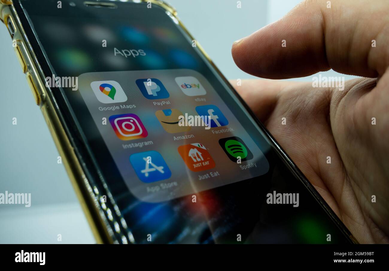 close up hand holding a mobile phone with a screen of various ...