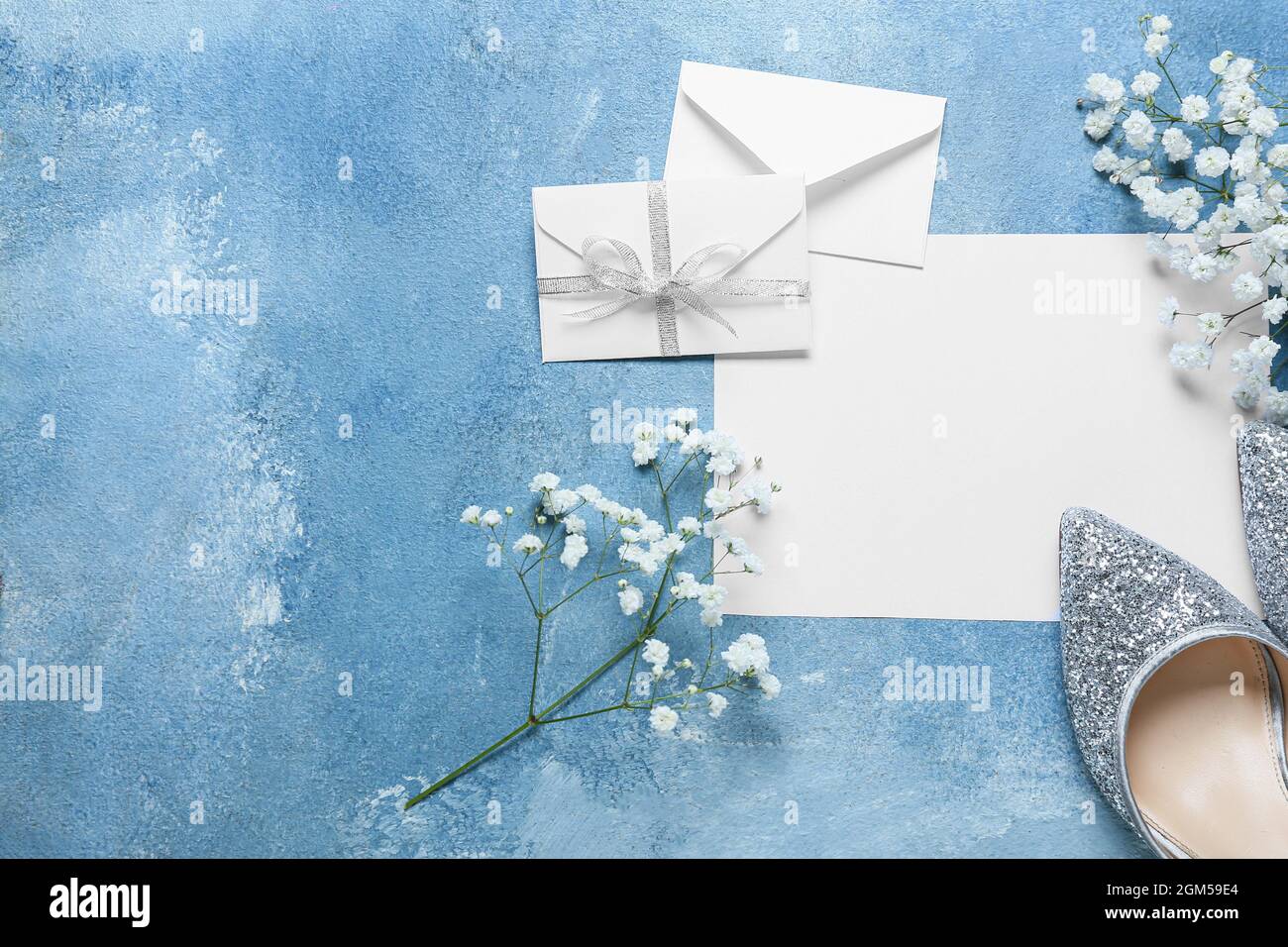 Blank card with envelopes, flowers and shoes on blue background Stock ...