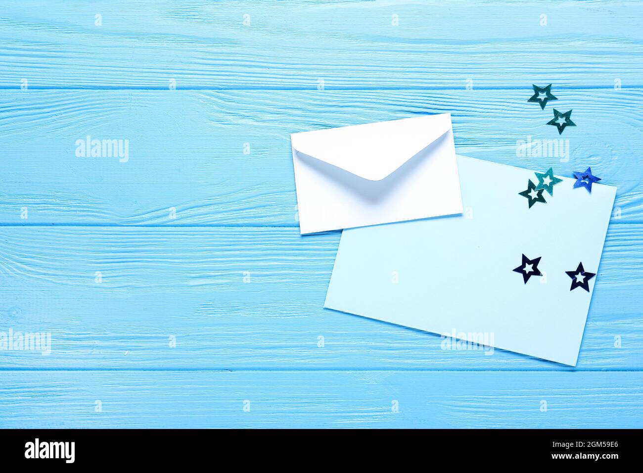 Blank card with envelope and stars on blue wooden background Stock ...