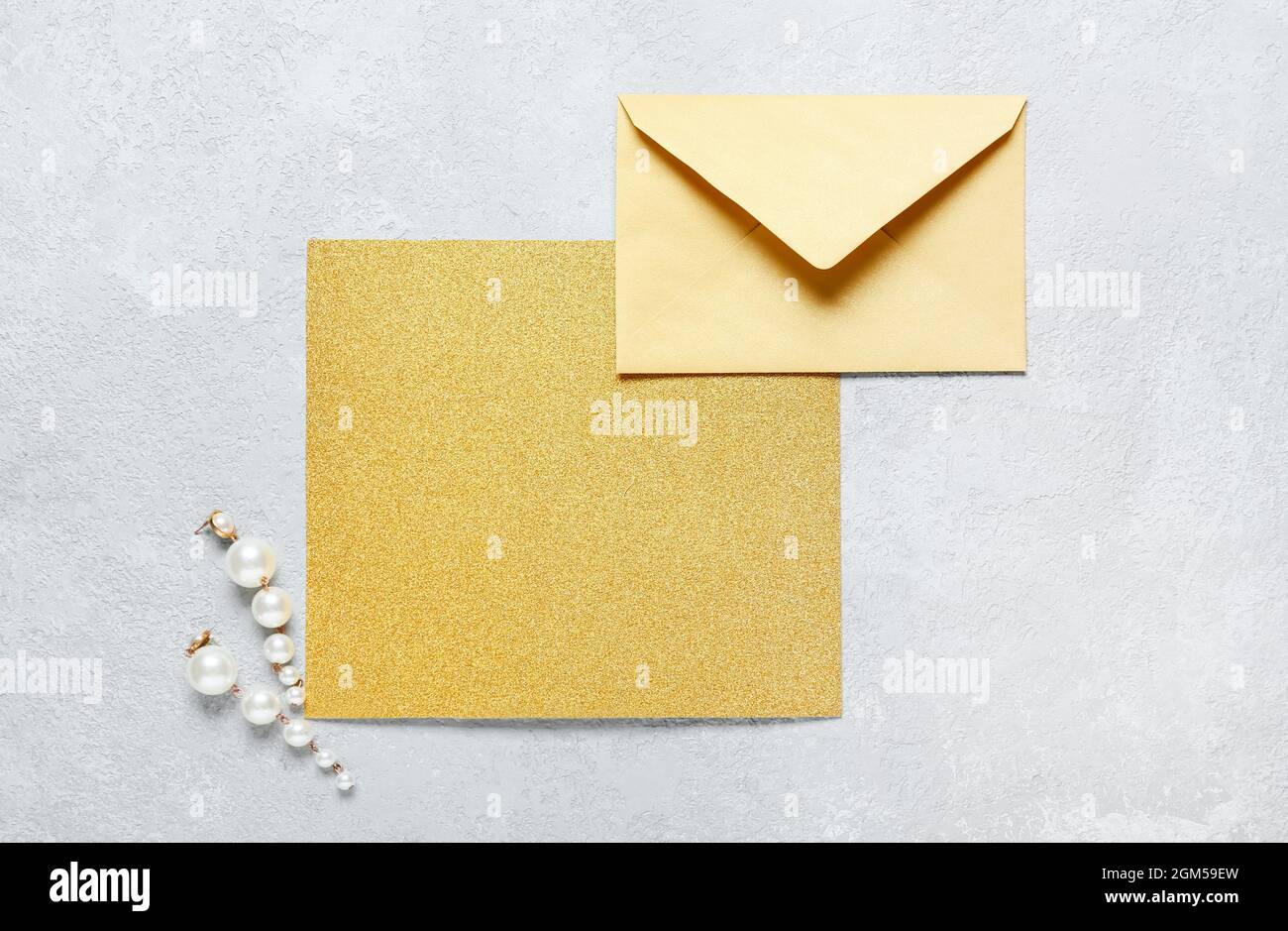Blank card with envelope and earrings on white background Stock Photo ...