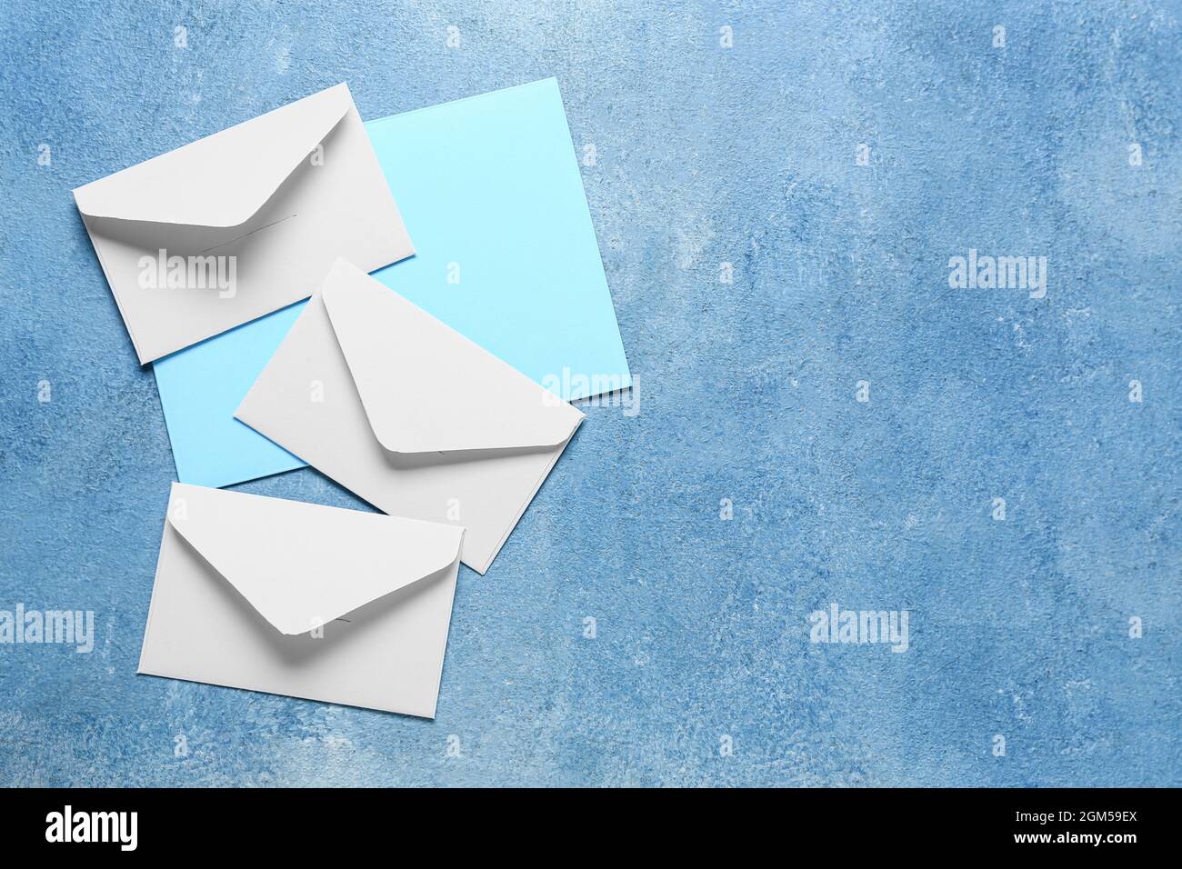 Blank card with envelopes on blue background Stock Photo - Alamy
