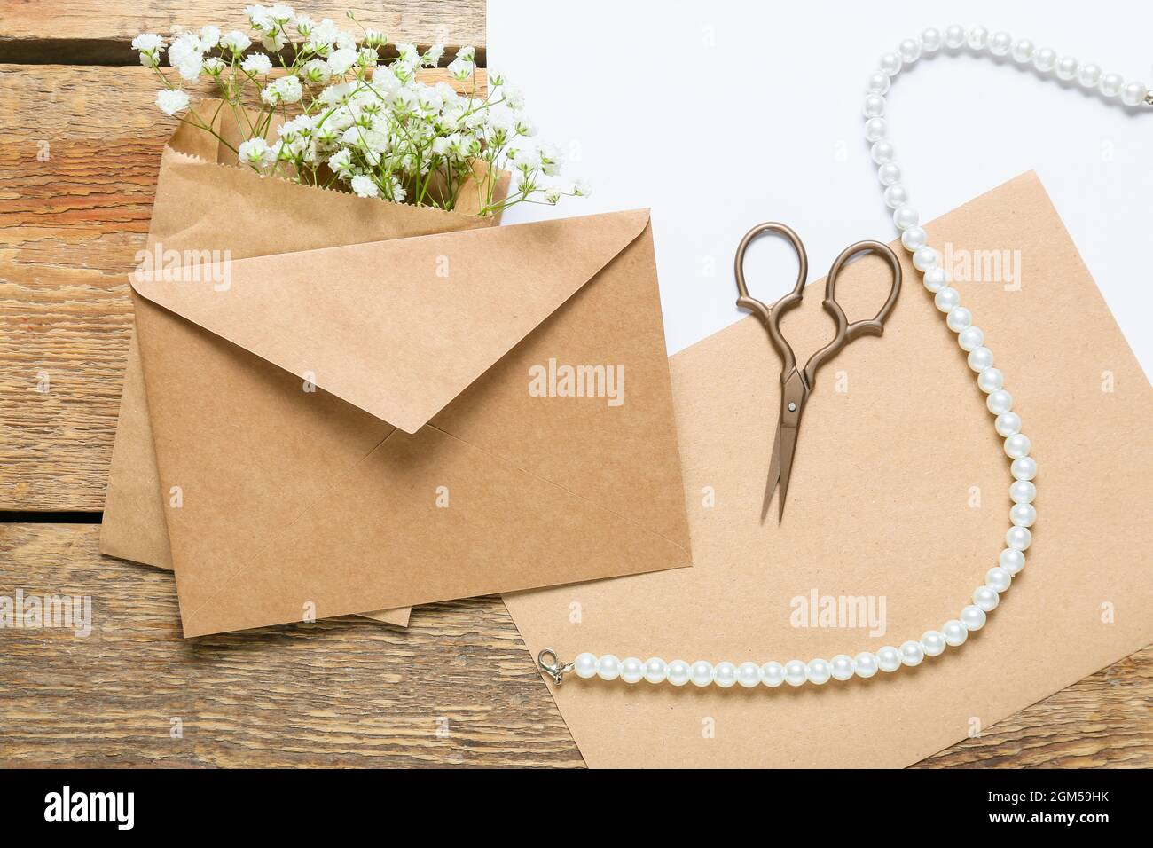 Envelope with cards, scissors and flowers on wooden background Stock ...