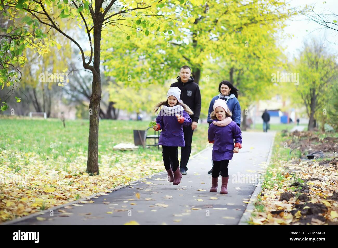 Children for a walk in autumn park. Leaf fall in the park. Family. Fall ...