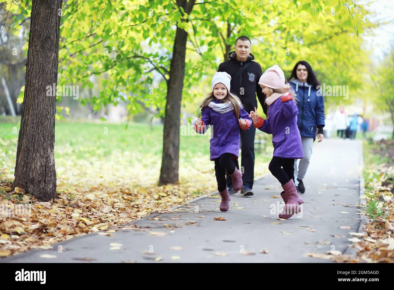 Children for a walk in autumn park. Leaf fall in the park. Family. Fall ...