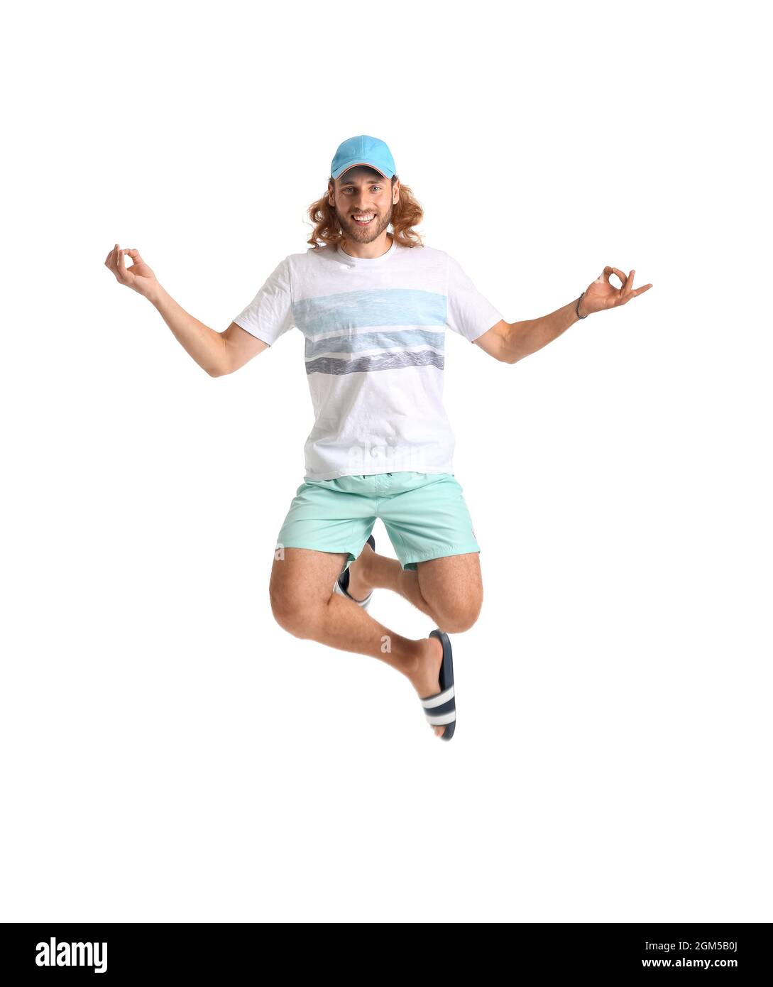 Handsome jumping meditating guy on white background Stock Photo - Alamy