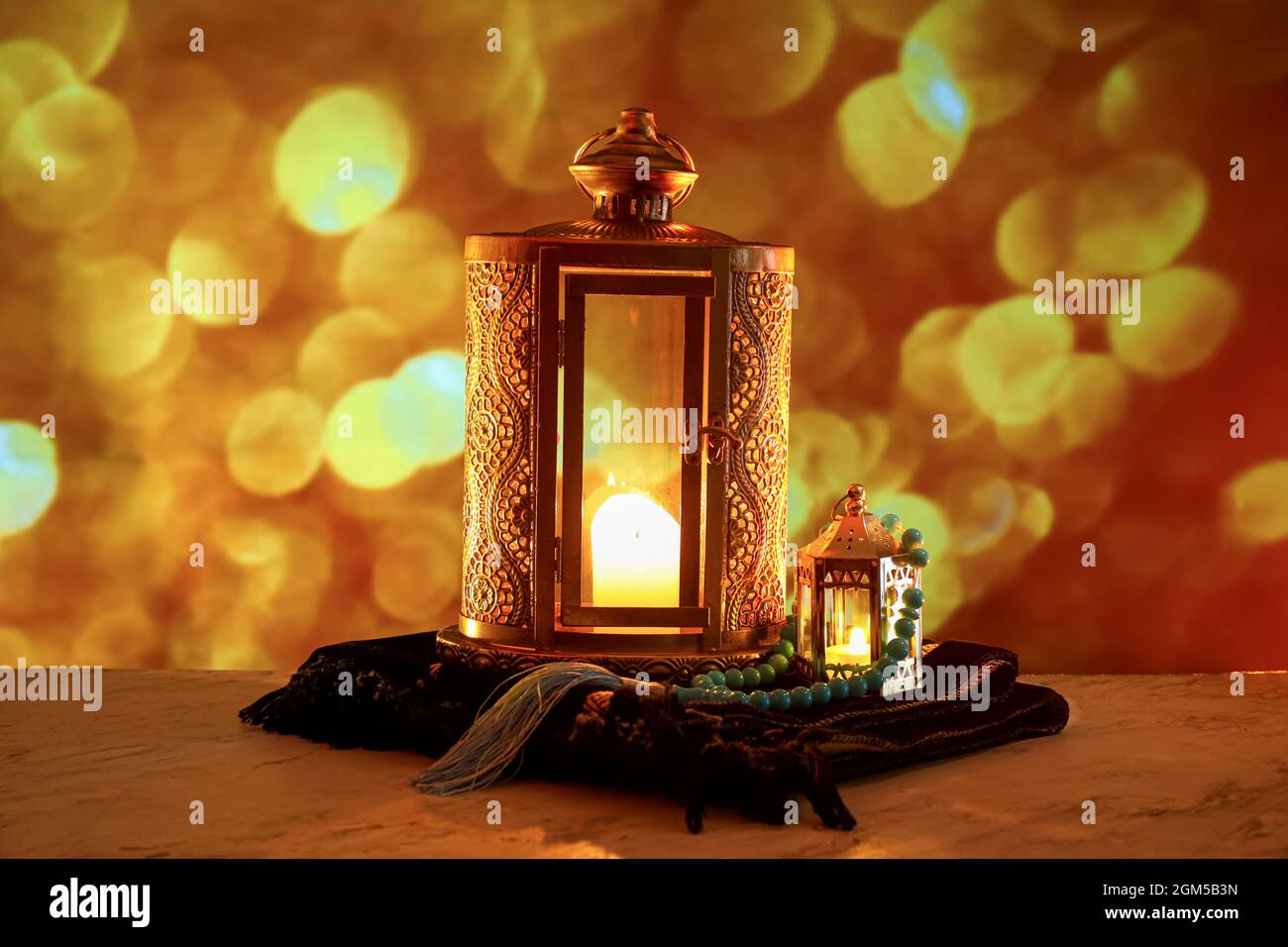 Islamic lamps with tasbih and carpet against blurred lights Stock Photo ...