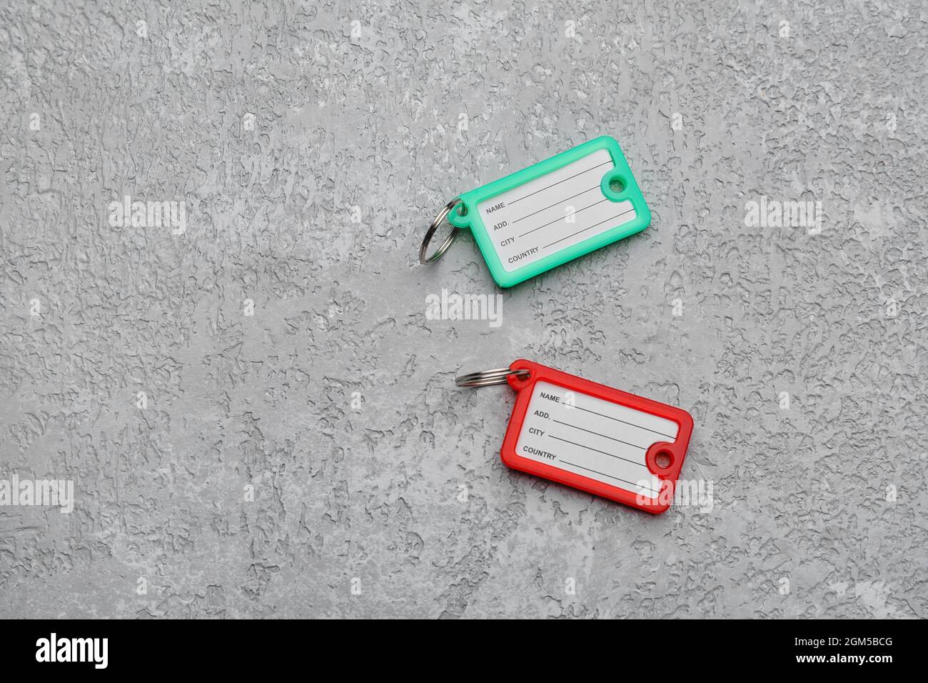 Plastic key tags on grunge background Stock Photo - Alamy