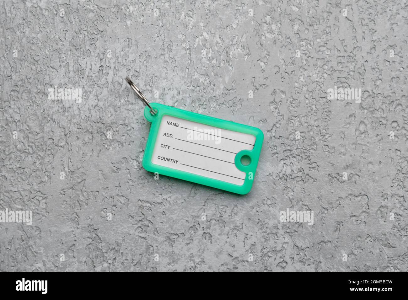 Plastic key tag on grey background Stock Photo - Alamy
