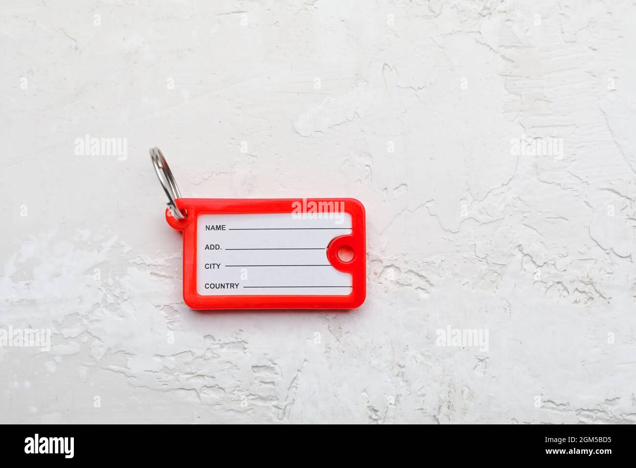 Plastic key tag on light background Stock Photo - Alamy