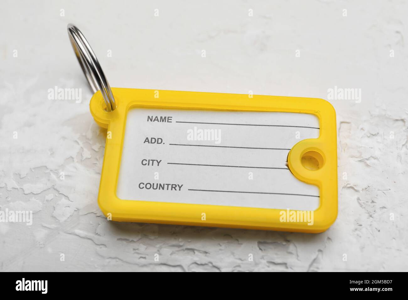 Plastic key tag on light background Stock Photo - Alamy