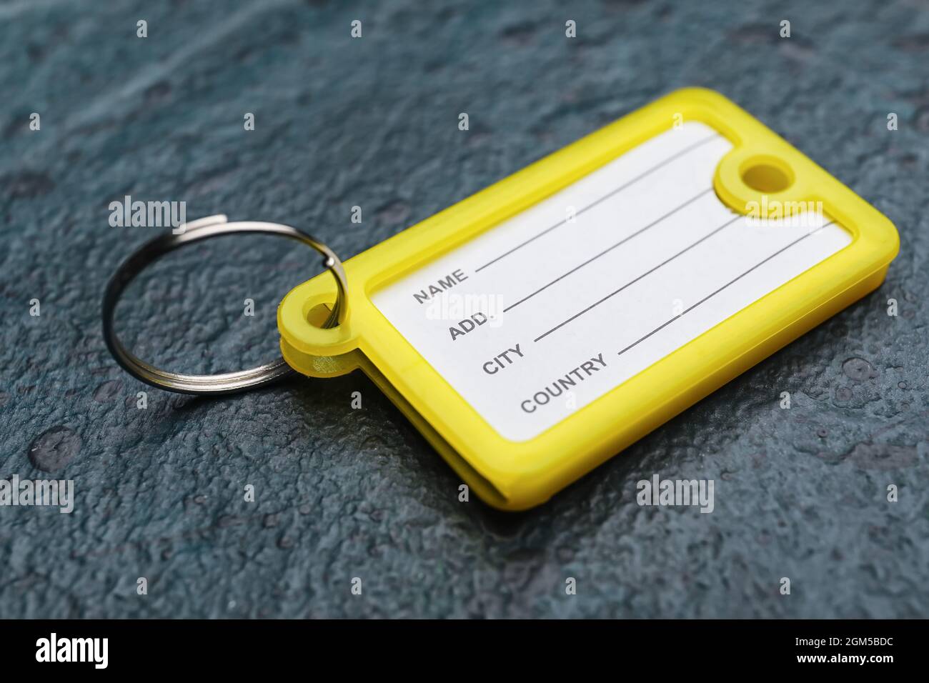 Plastic key tag on dark background Stock Photo - Alamy