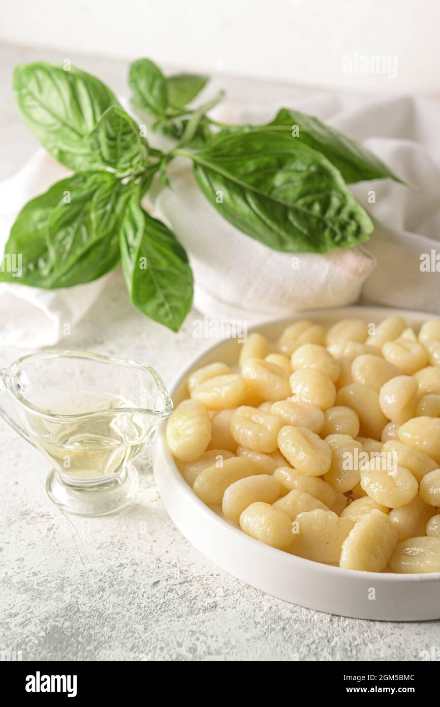 Plate with tasty gnocchi on light background, closeup Stock Photo - Alamy