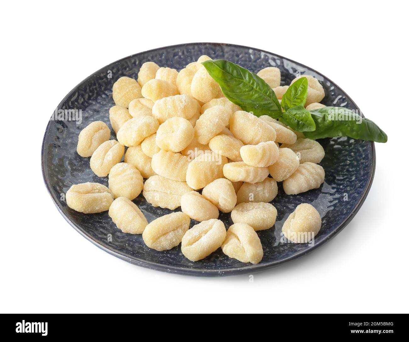 Plate with raw gnocchi on white background Stock Photo - Alamy