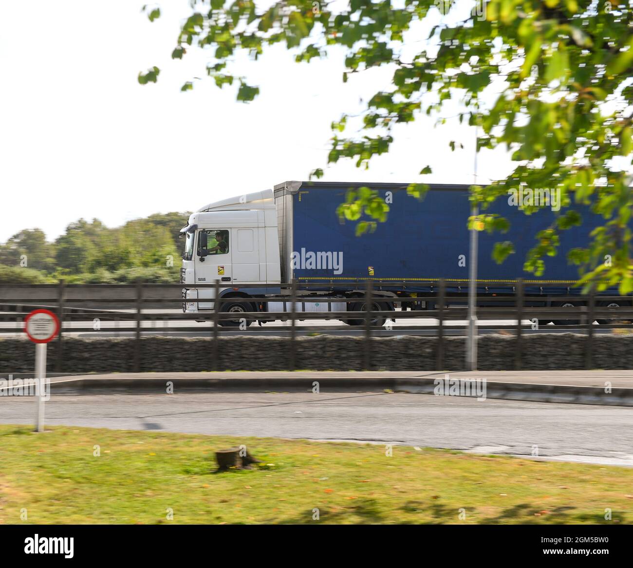 A blue sided un-marked HGV lorry drives on the M27 motorway near ...