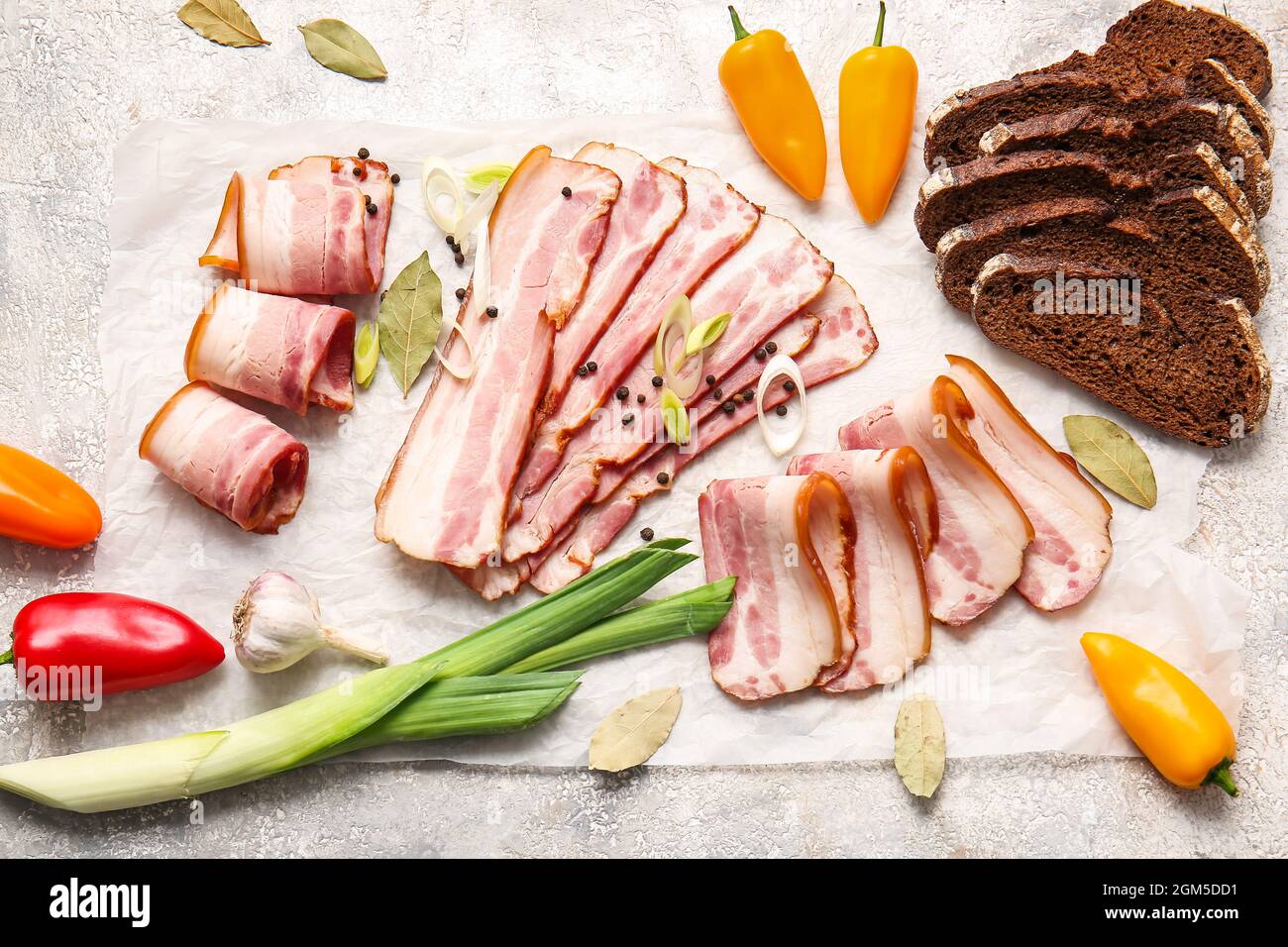Composition with slices of tasty smoked bacon on light background Stock ...