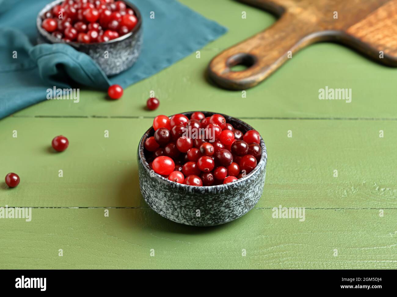 Bowl with healthy cranberries on color wooden background Stock Photo ...