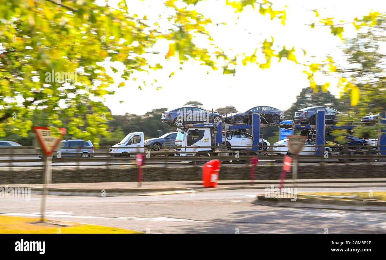 Tesla cars loaded on to a large car transporter drives on the M27 at ...