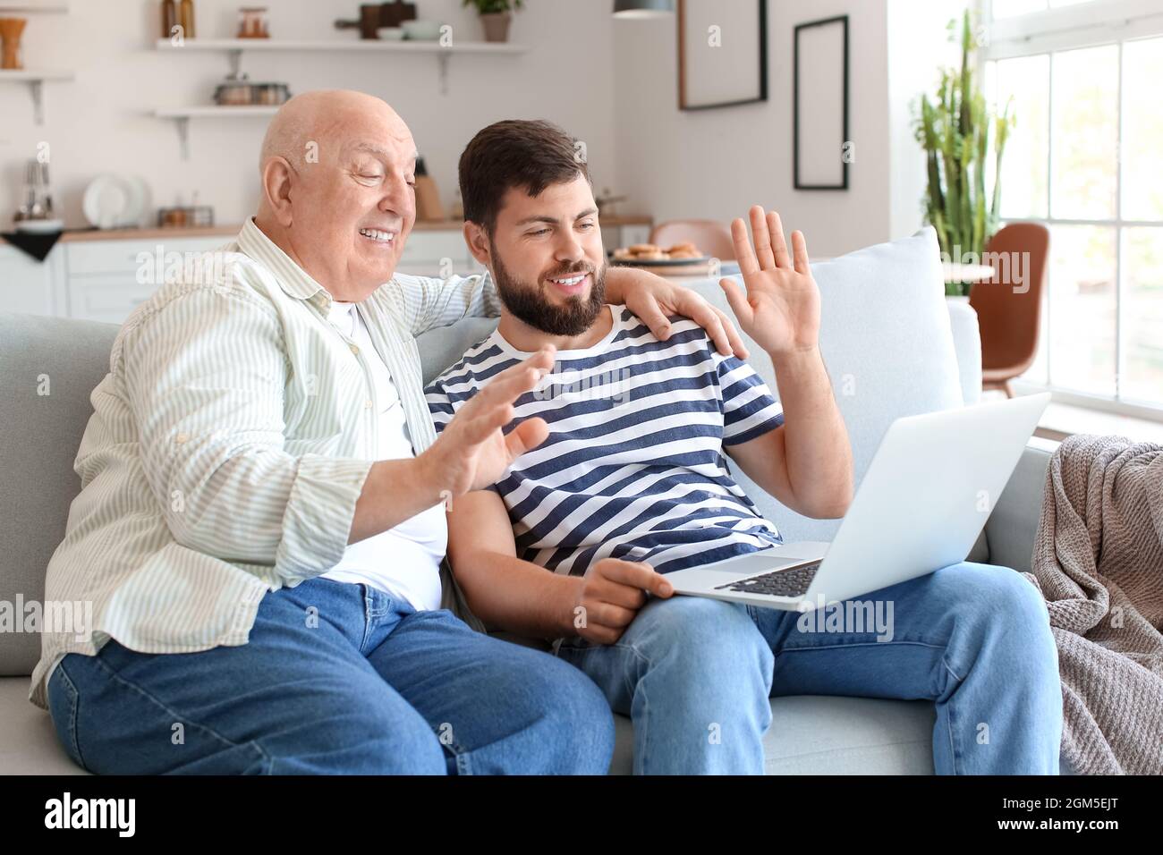 Man and his father with laptop video chatting at home Stock Photo - Alamy
