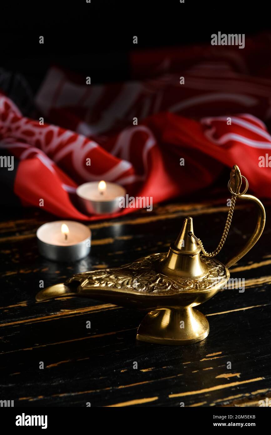 Lamp, candles and flag of Afghanistan on table against dark background ...