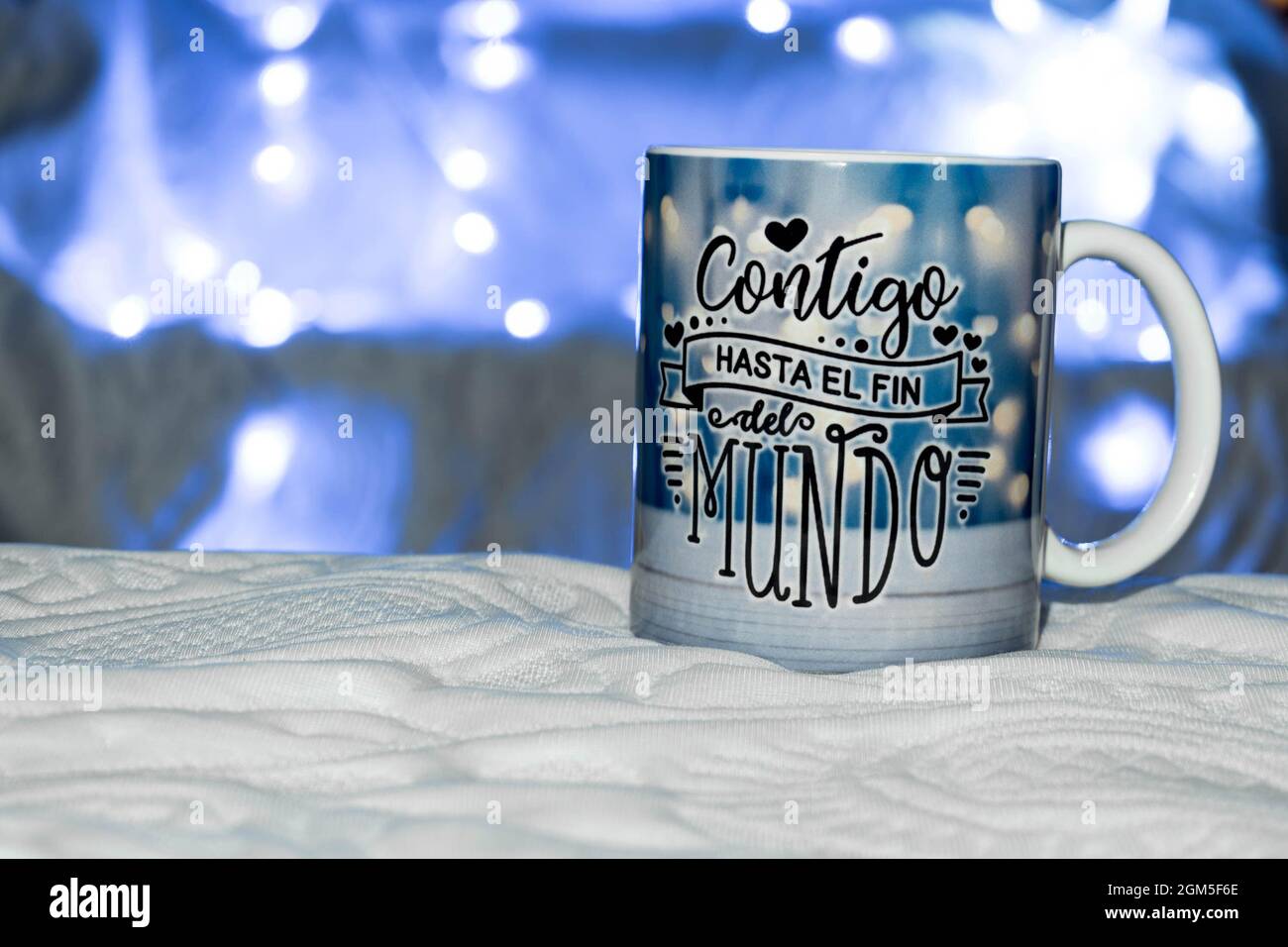 mug with thoughtful phrase, on the bed, mug on white cloth, blue ...