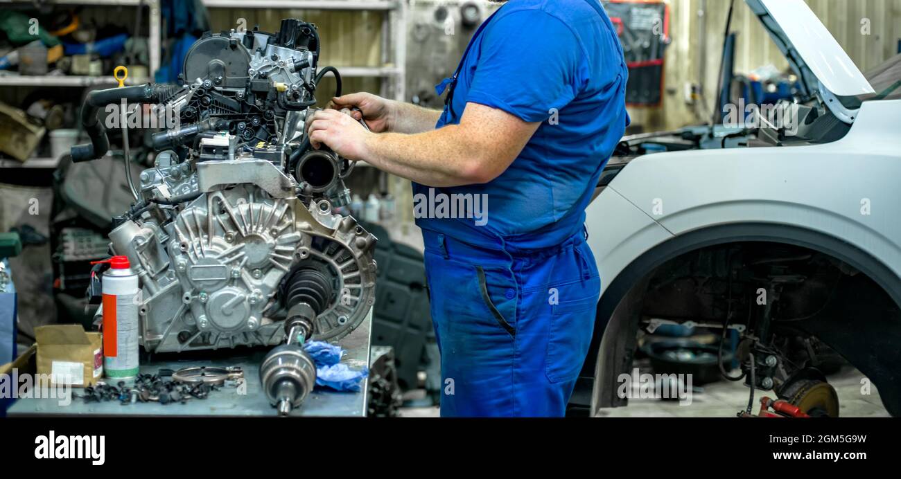 repair of a car engine in a car workshop at a shallow depth of field ...