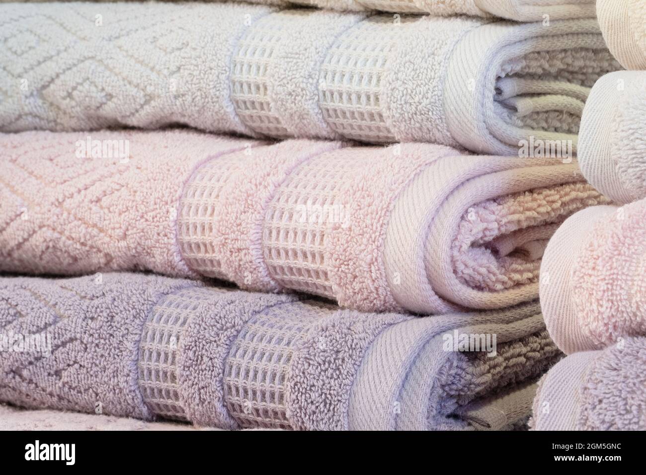 Colorful folded towels stack closeup picture Stock Photo - Alamy