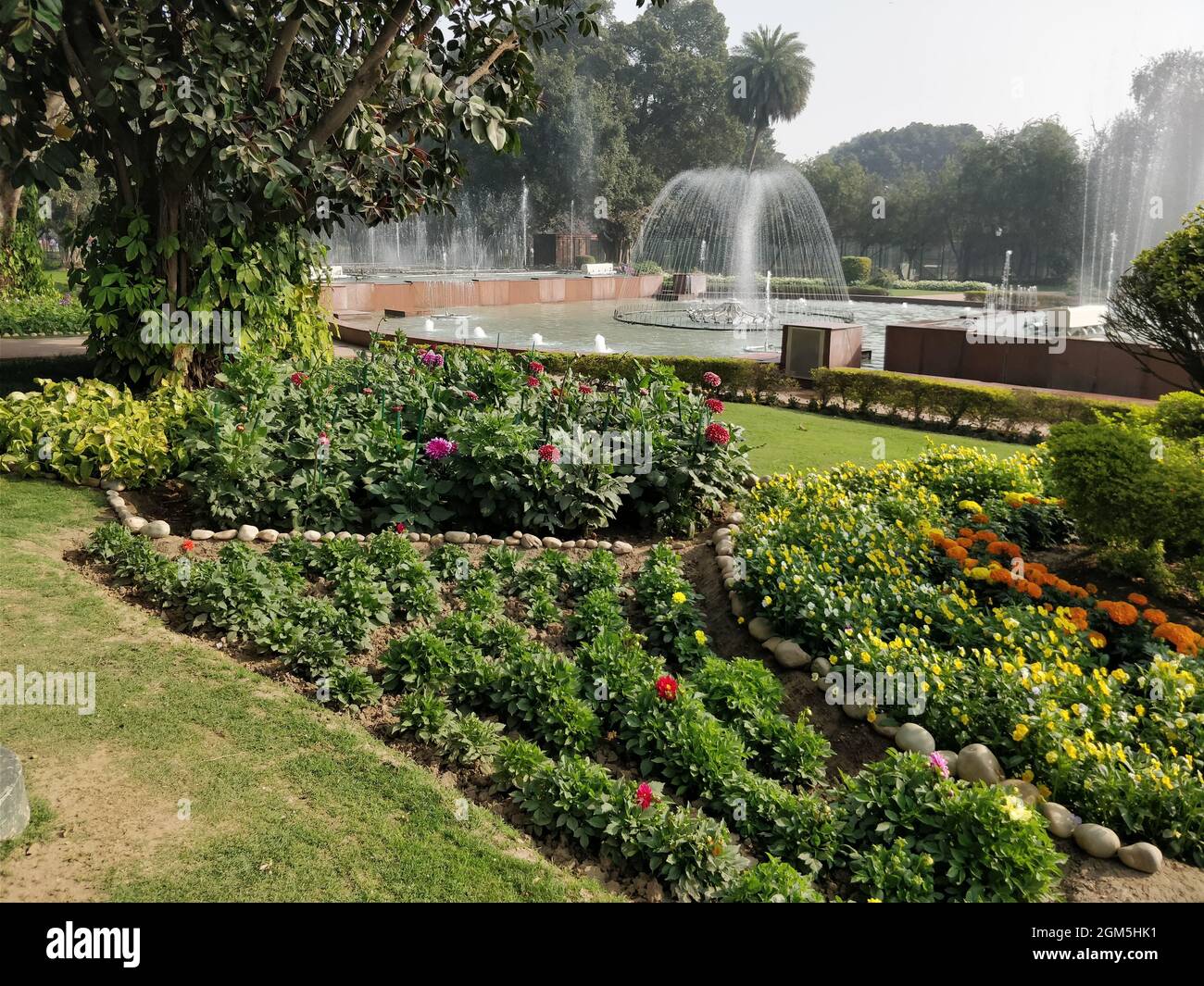 Landscape of fountains surrounded by greenery and flowers in Mughal ...