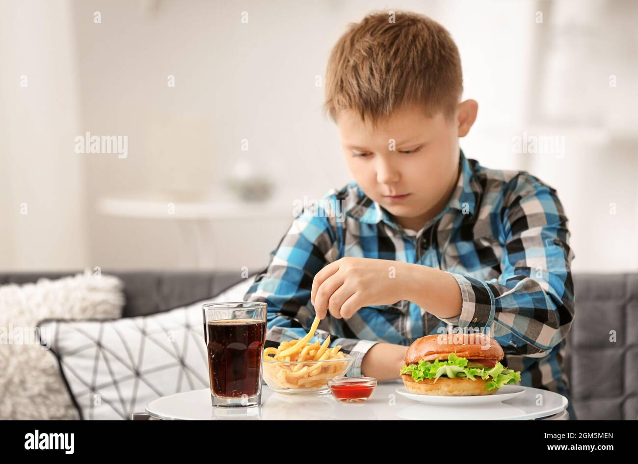 Chubby kid junk food hi-res stock photography and images - Alamy