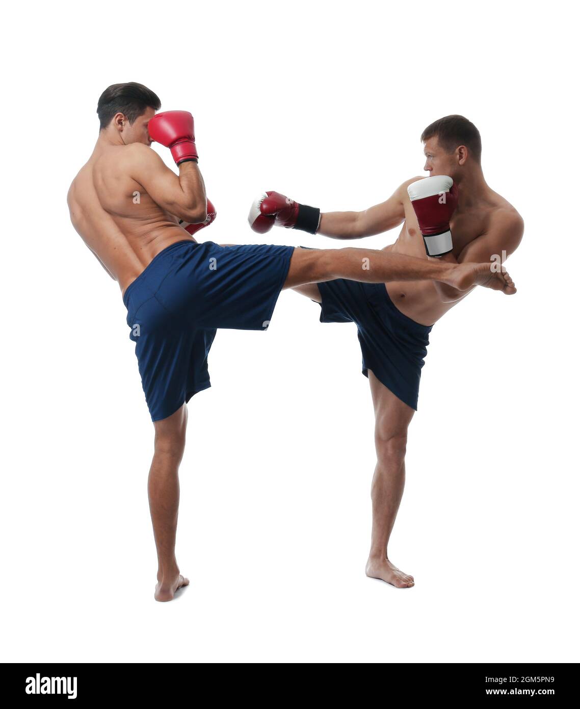 Attractive young kickboxers fighting on white background Stock Photo ...