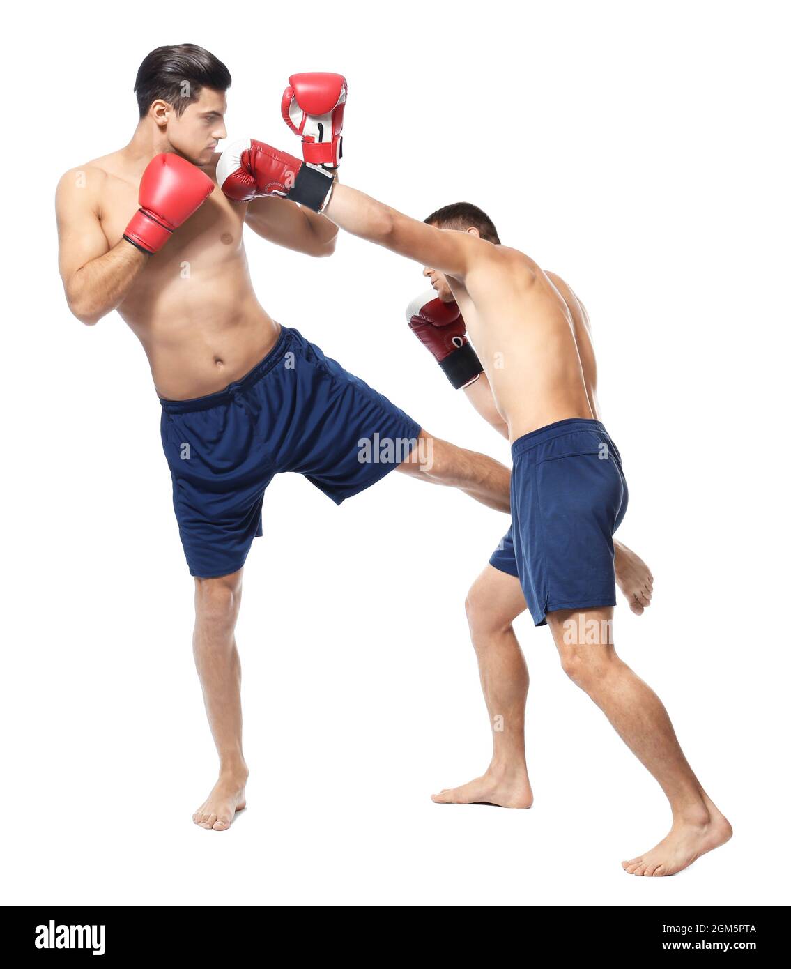 Attractive young kickboxers fighting on white background Stock Photo ...