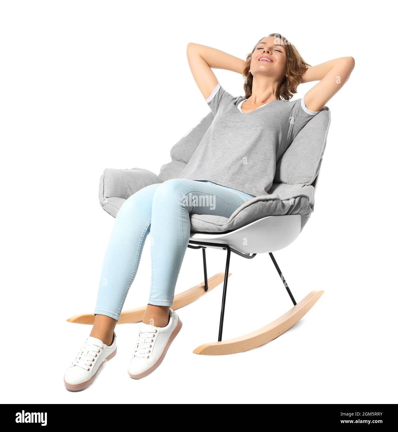 Happy young woman relaxing in armchair on white background Stock Photo ...