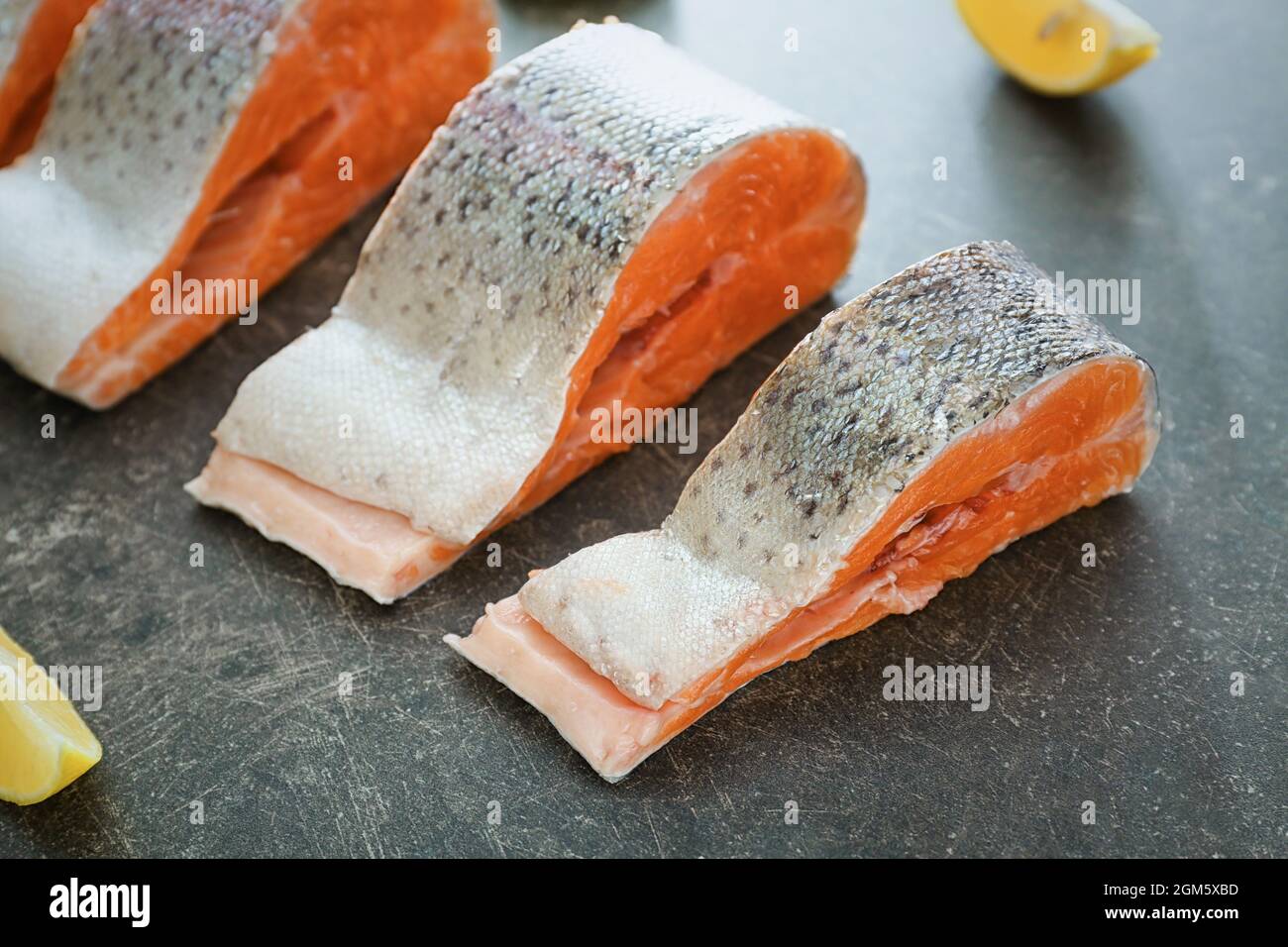 Cut rainbow trout on grey background Stock Photo - Alamy