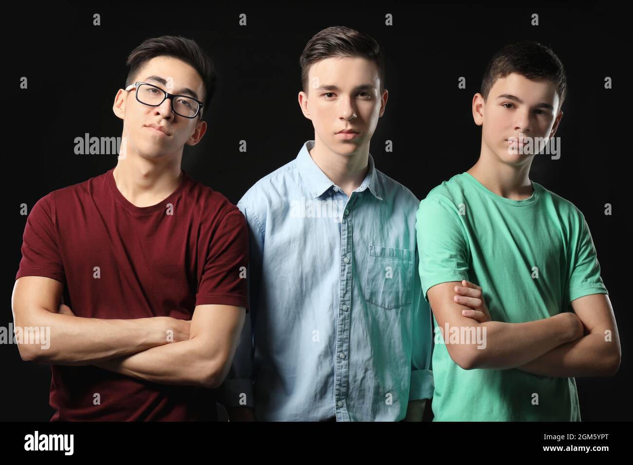 Cool teenage boys on dark background Stock Photo - Alamy
