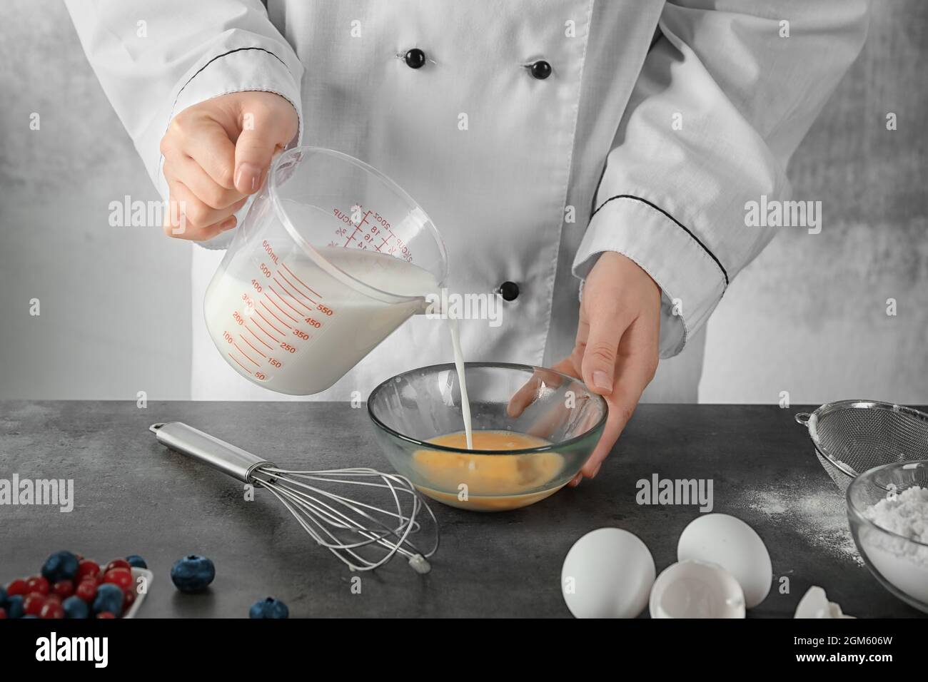 Female chef cooking pastries in kitchen Stock Photo - Alamy