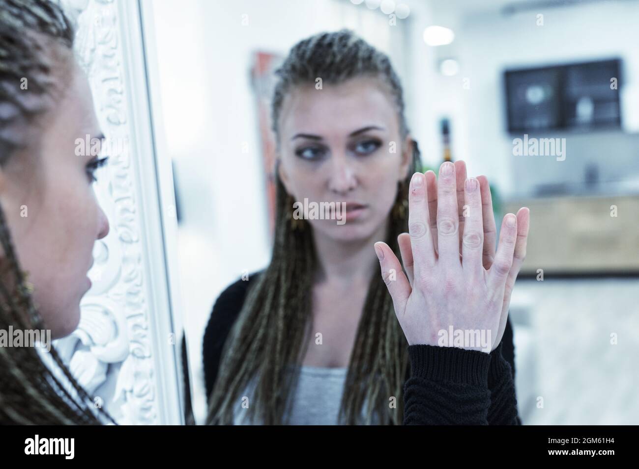young girl with dreadlocks loves her image in the mirror imagining how ...