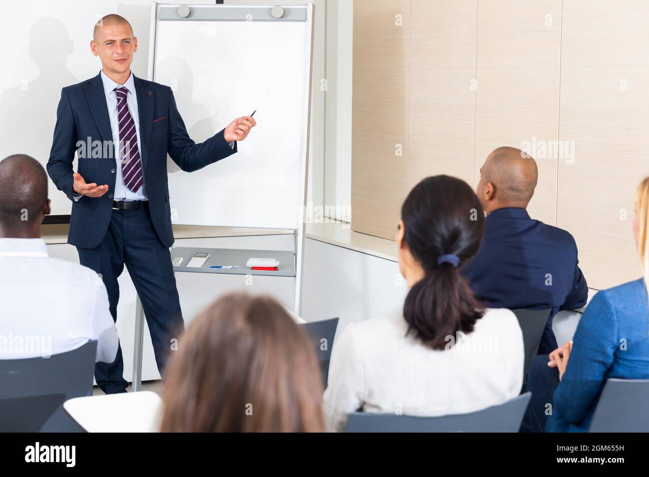 caucasian male instructor explained something to students in meeting ...