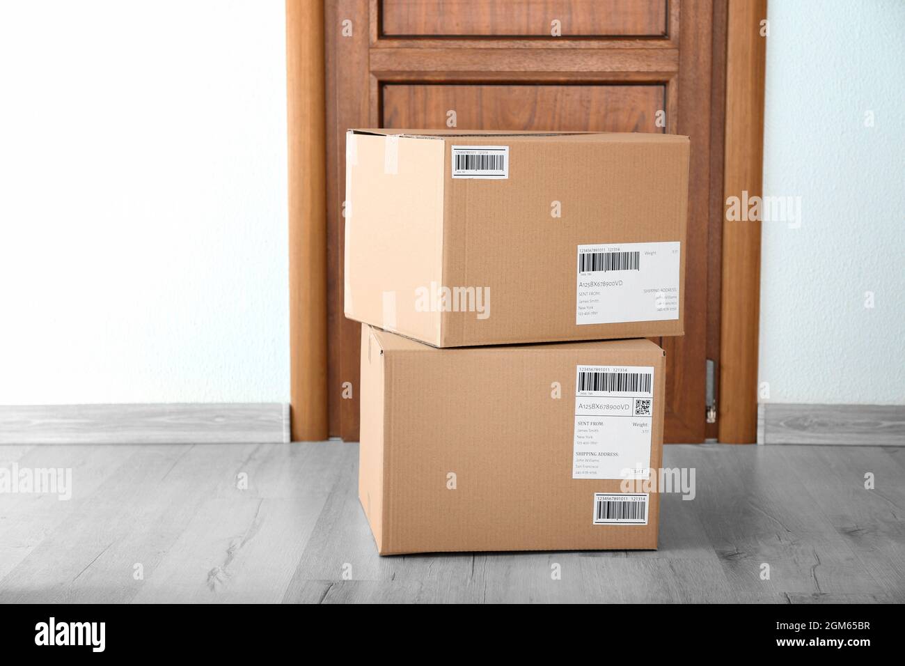 Delivered parcels on floor near front door Stock Photo - Alamy