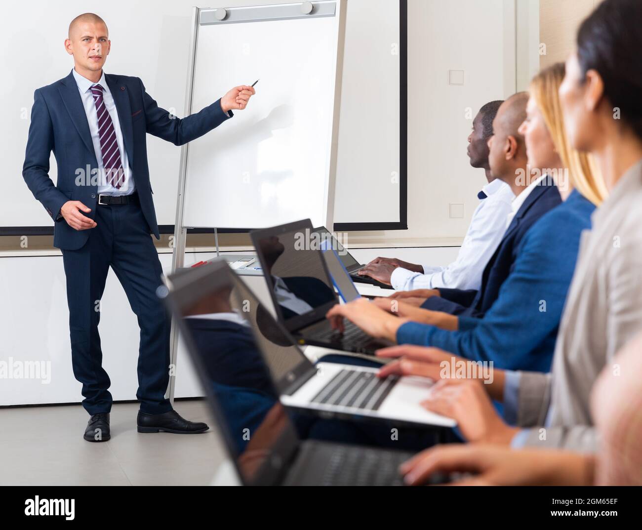 Man giving presentation to colleagues at business meeting Stock Photo ...