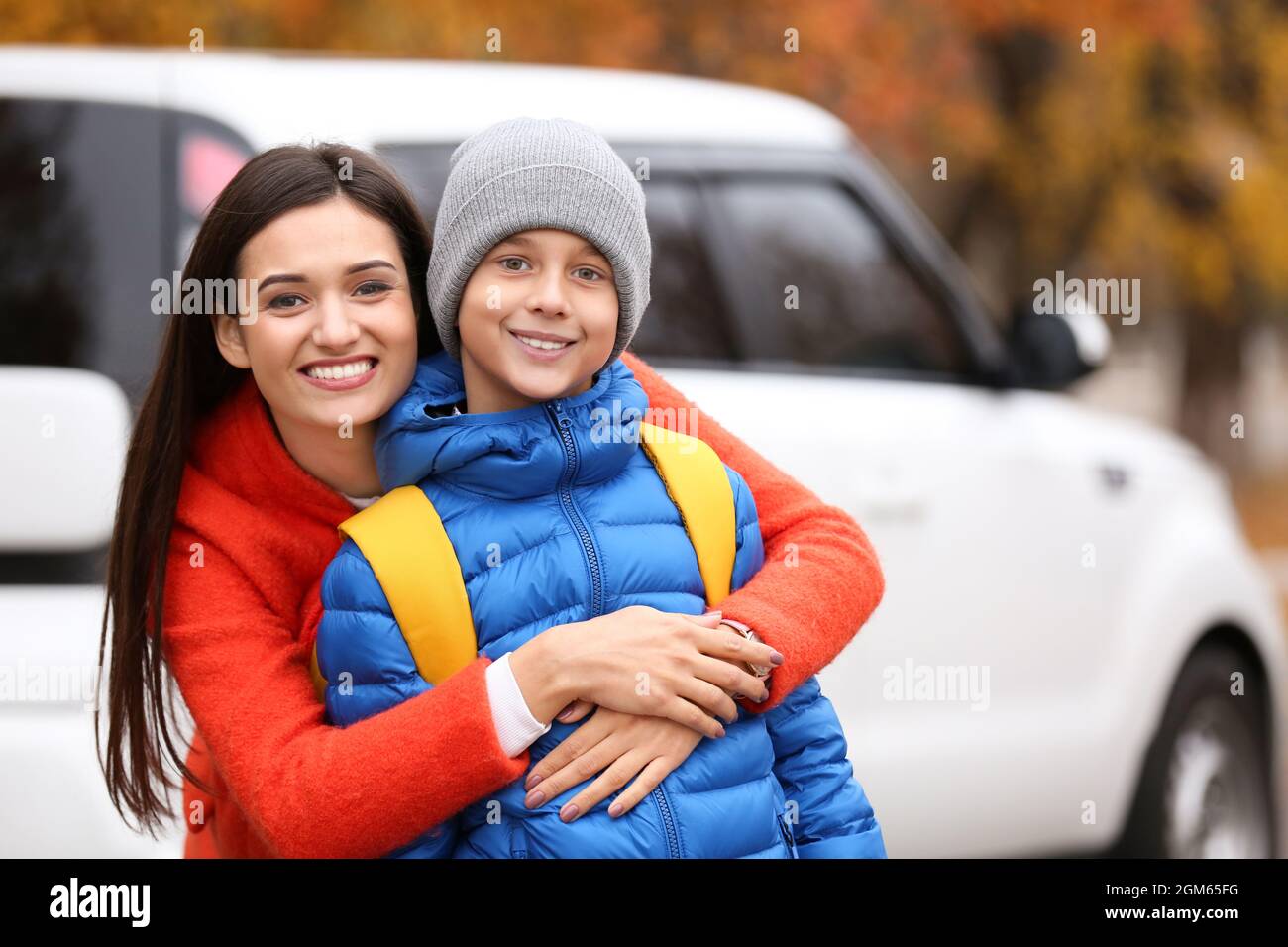 Young mother hugging her son before school Stock Photo - Alamy