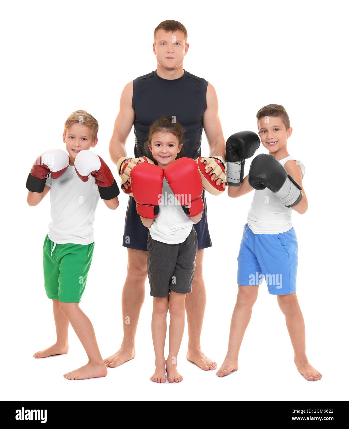 Cute little children in boxing gloves and their coach on white ...