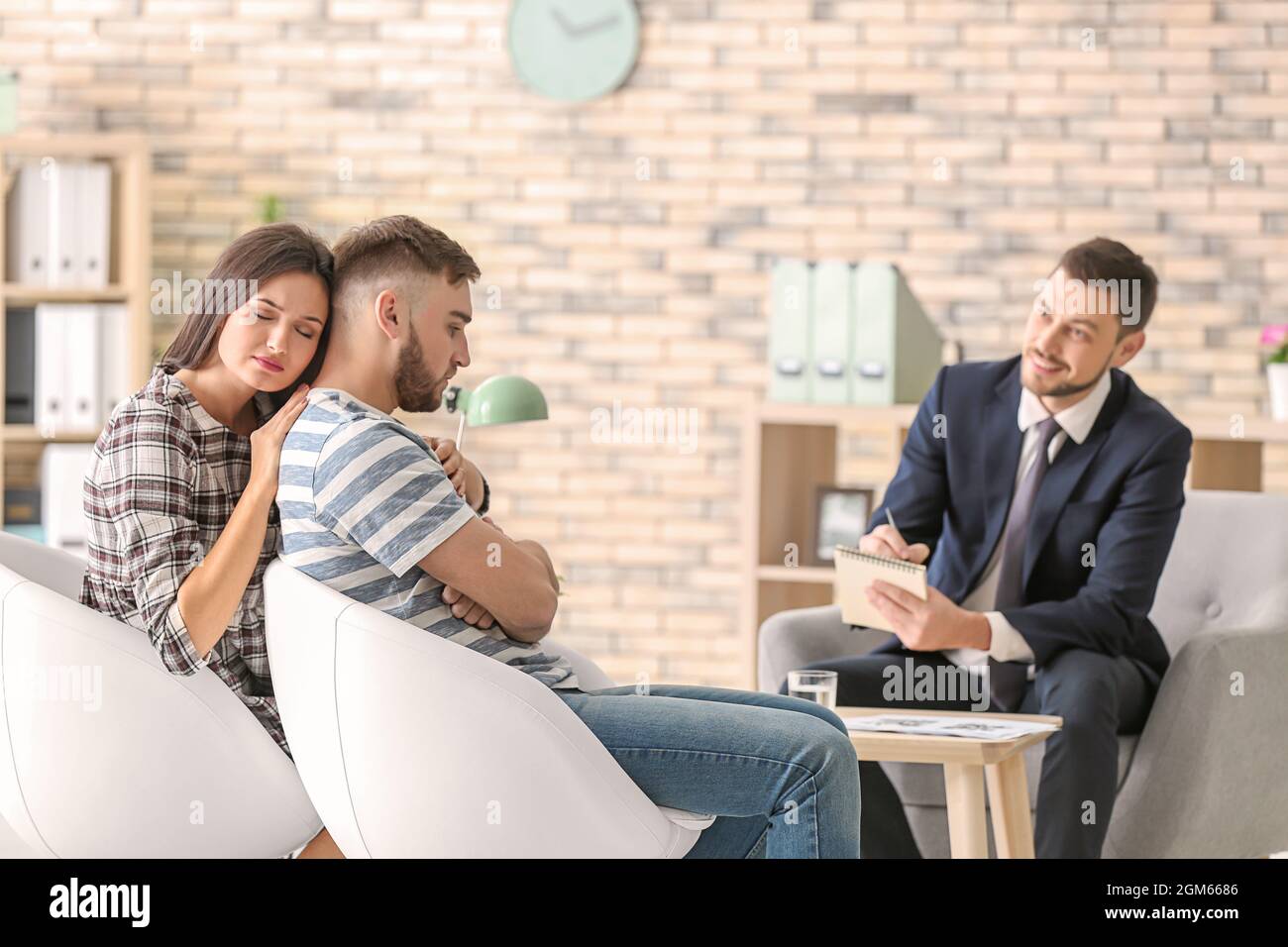Psychologist working with married couple in office Stock Photo - Alamy