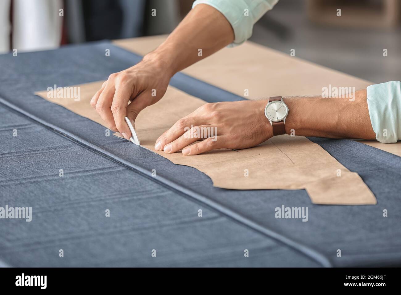 Young tailor working with sewing pattern, closeup Stock Photo - Alamy
