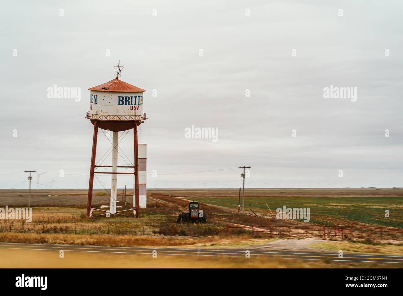 Old Britten Water tower leaning along the roadside in Texas landscape ...