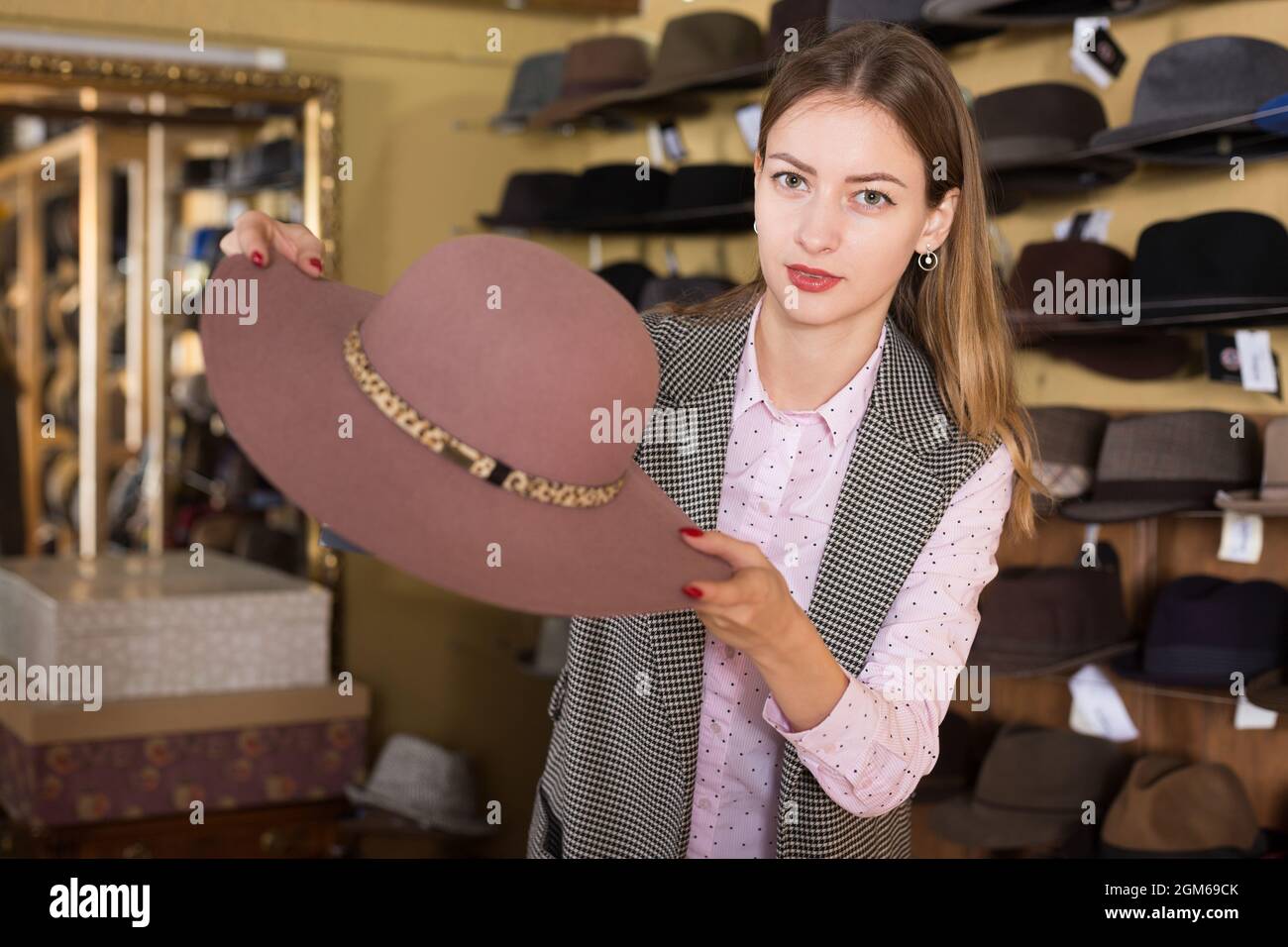 Woman choosing hat hi-res stock photography and images - Alamy