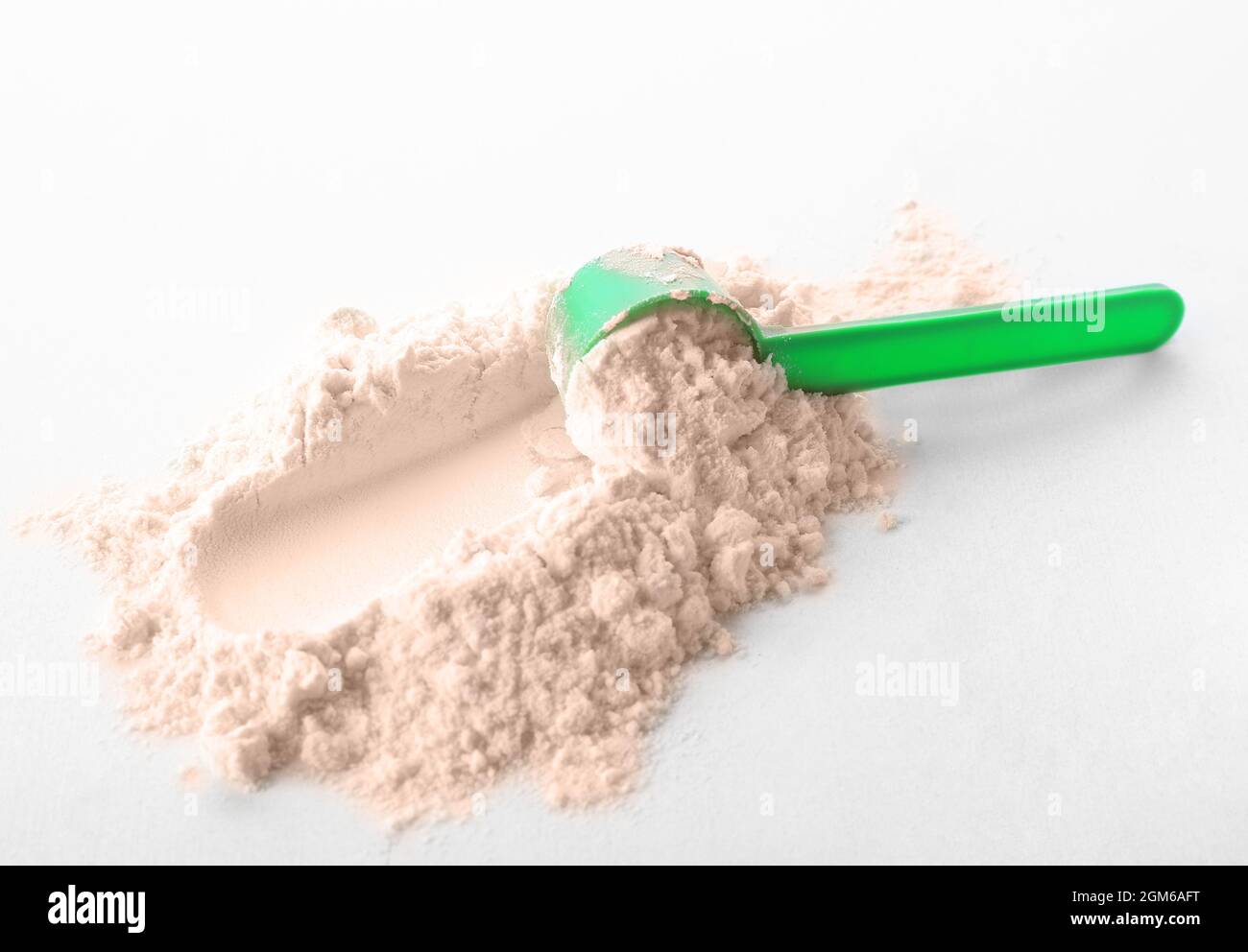 Measuring scoop and protein powder on white background Stock Photo - Alamy