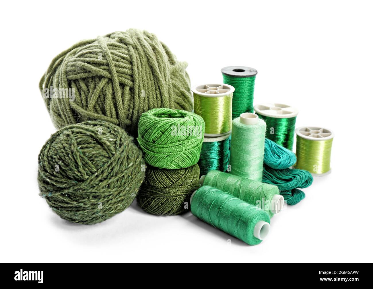 Green threads of different shades on white background Stock Photo - Alamy
