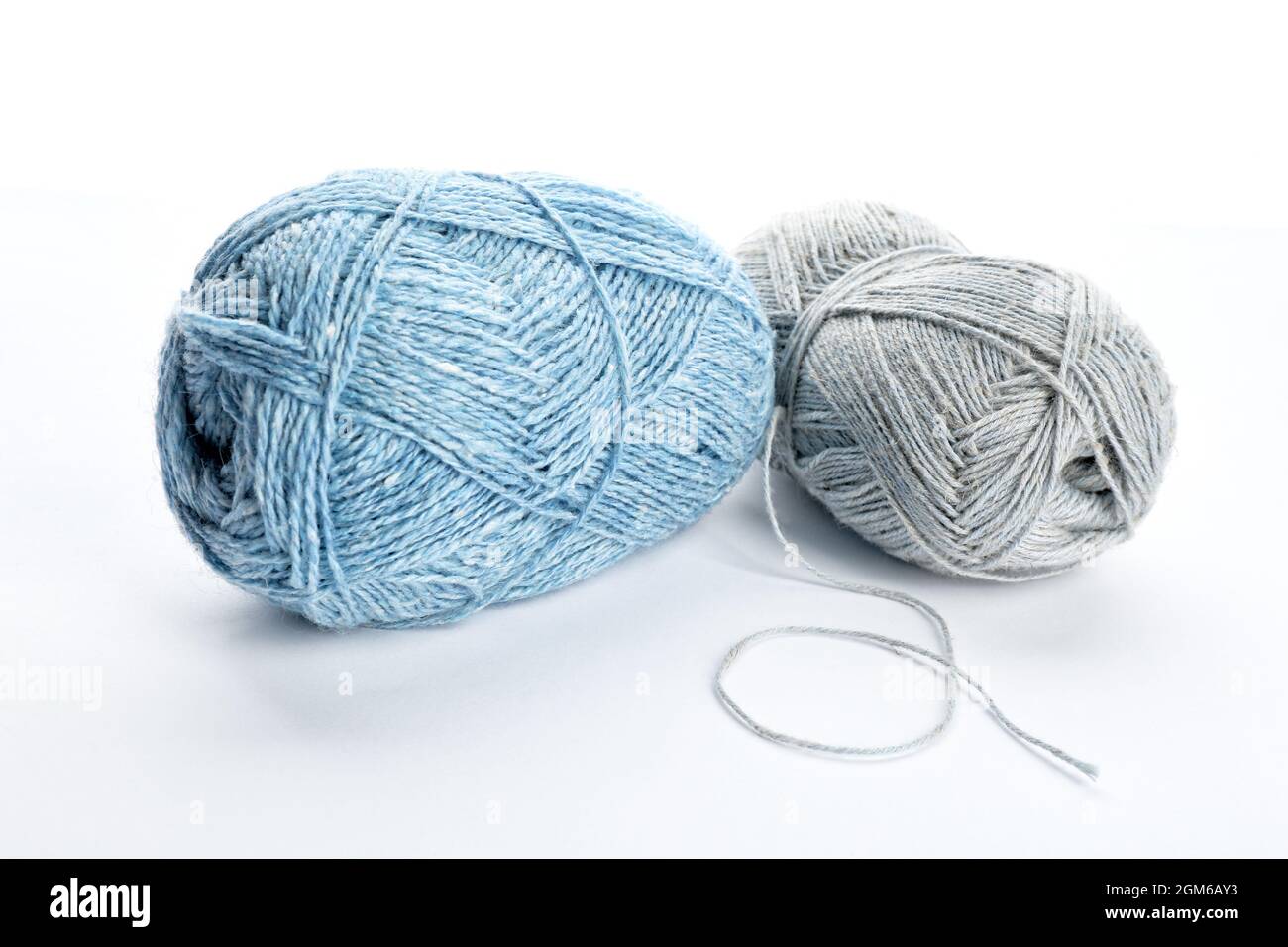 Colorful yarn bundles on white background Stock Photo - Alamy