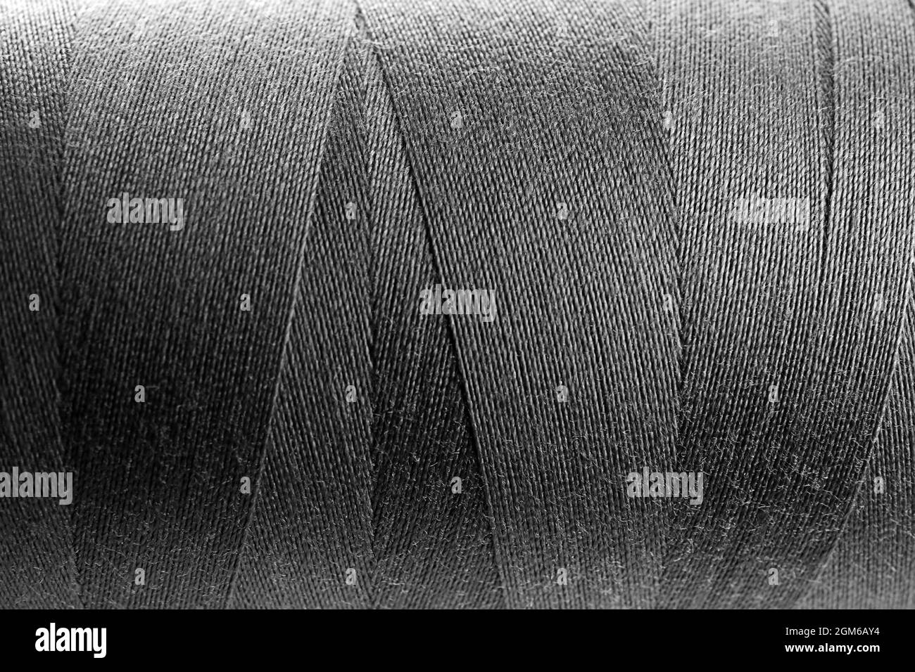 Dark grey thread bobbin, closeup Stock Photo - Alamy