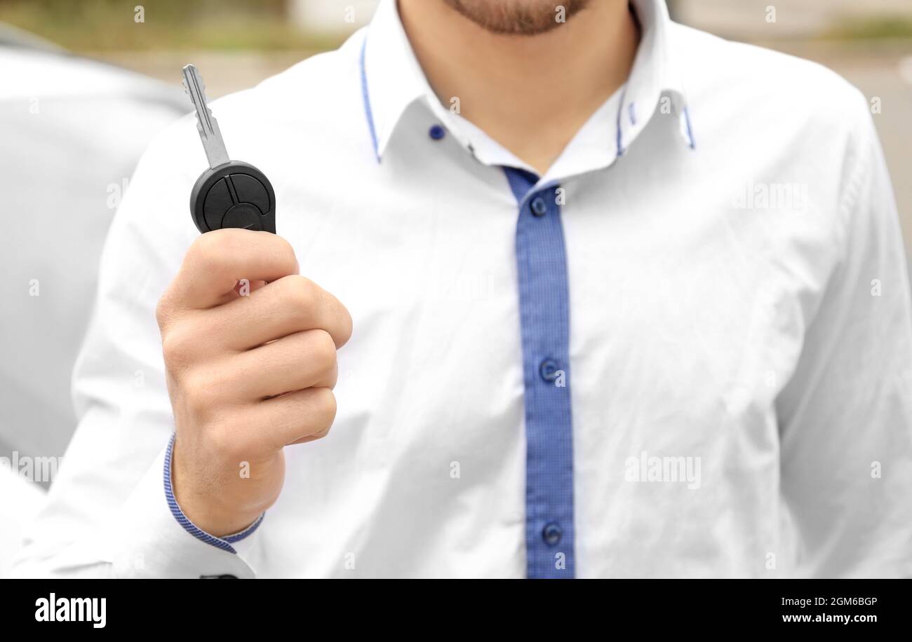 Man in office wear holding car key outdoors Stock Photo - Alamy