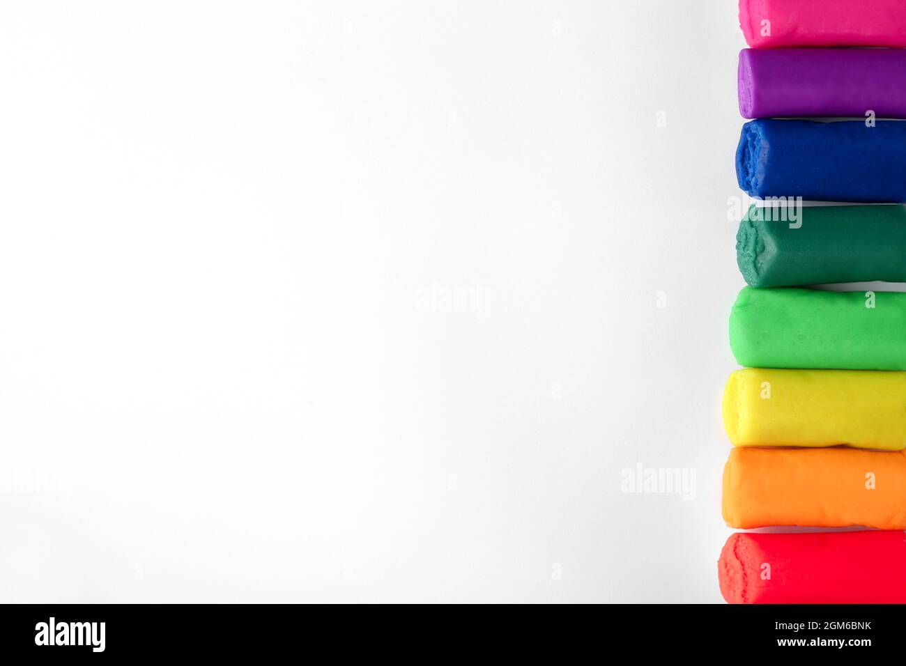 Rainbow play dough on white background Stock Photo - Alamy
